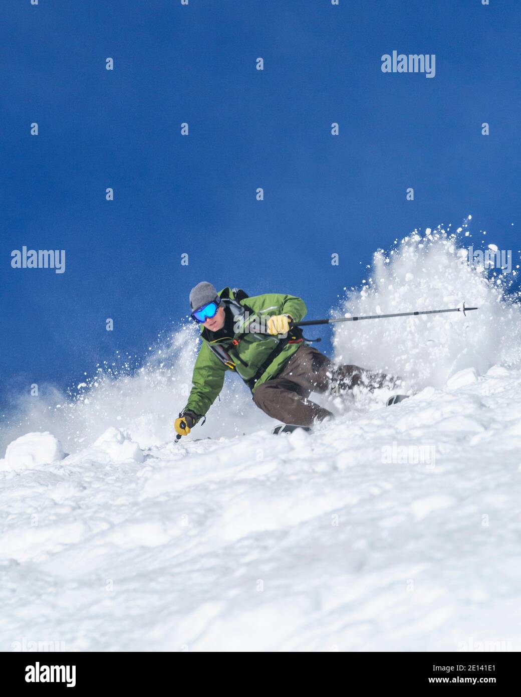 Alpine skier skiing on steep off-piste slope Stock Photo - Alamy