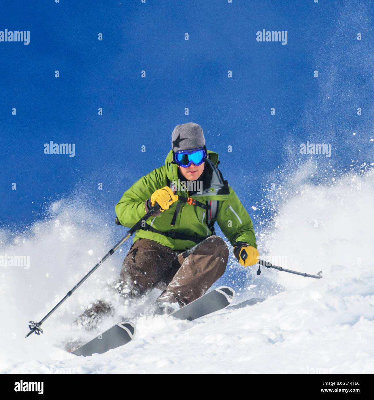 Alpine skier skiing on steep off-piste slope Stock Photo - Alamy