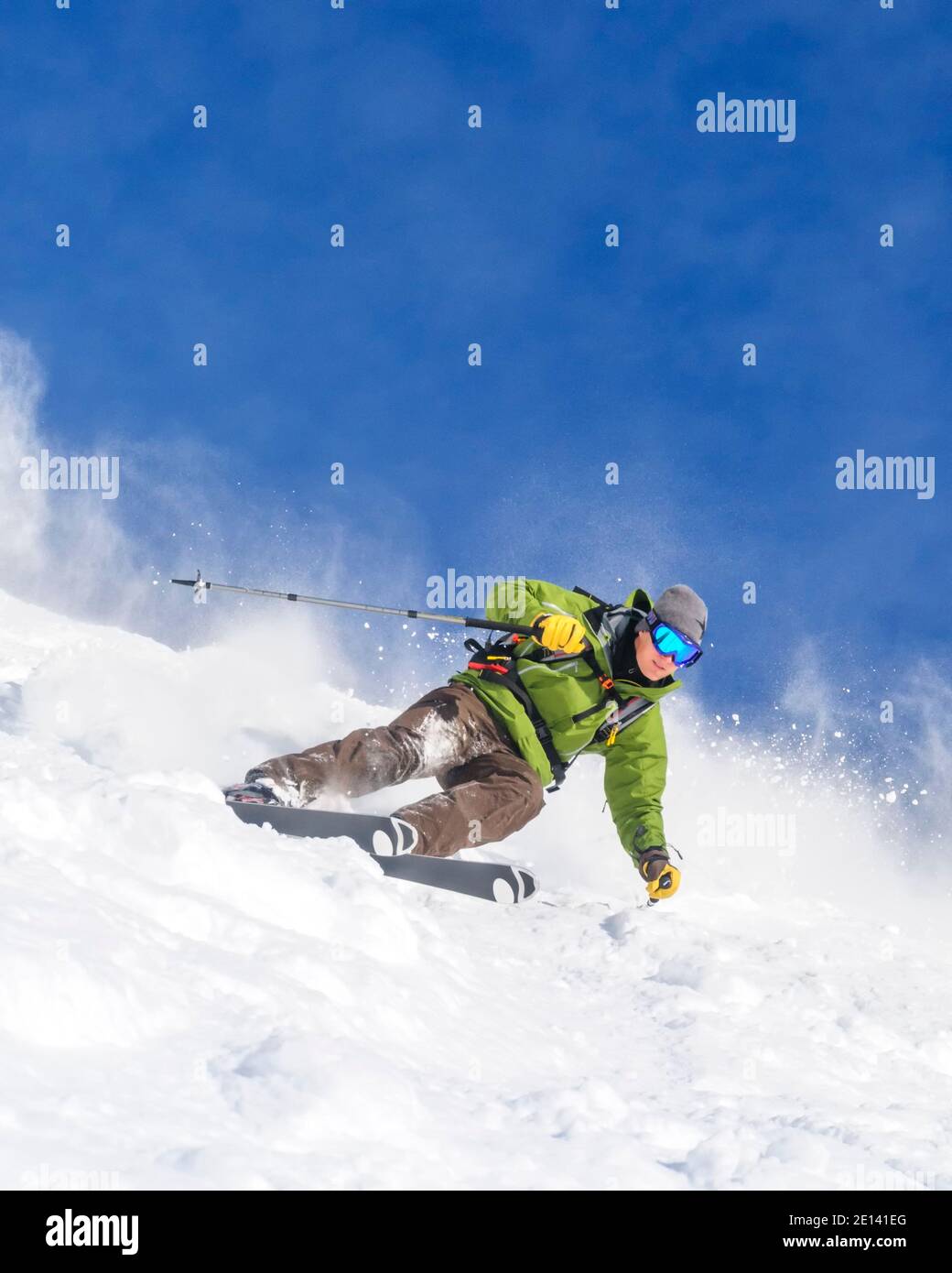 Alpine skier skiing on steep off-piste slope Stock Photo - Alamy