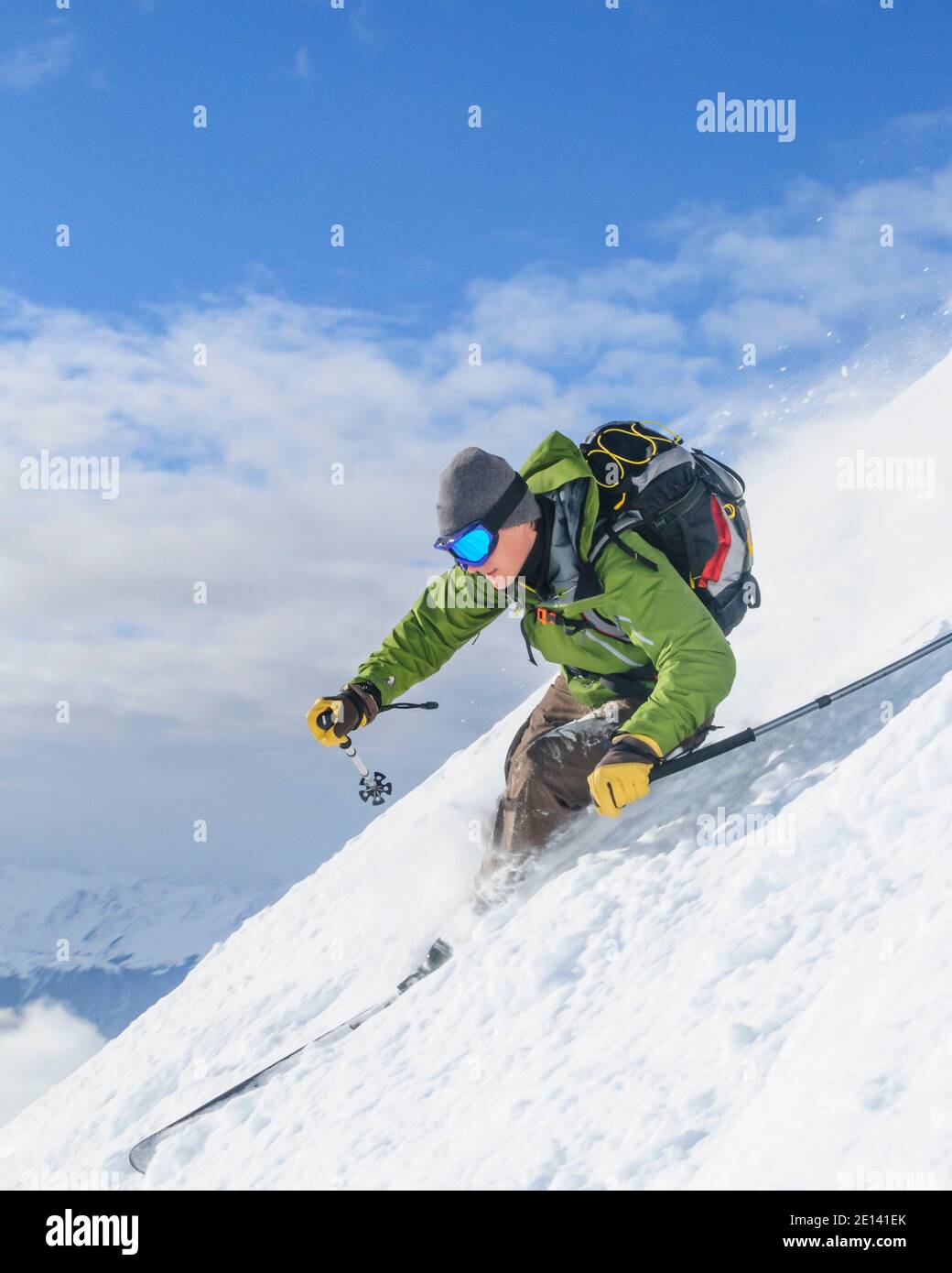 Alpine skier skiing on steep off-piste slope Stock Photo - Alamy