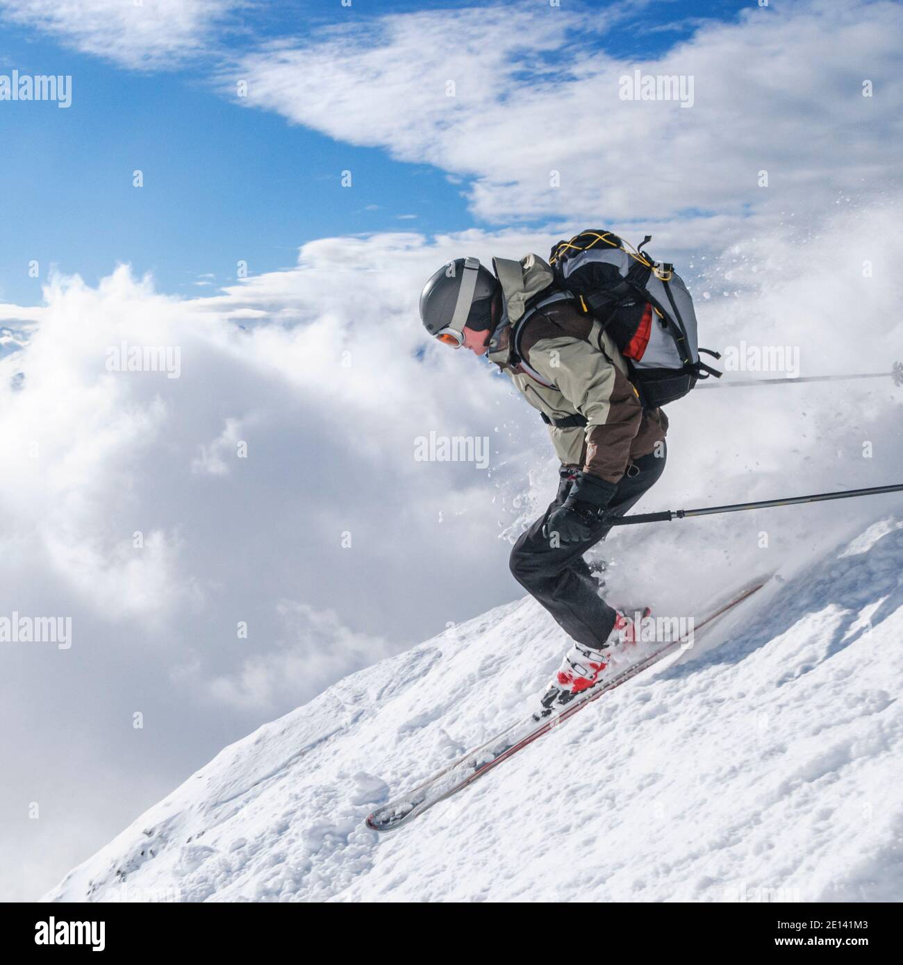 Alpine skier skiing on steep off-piste slope Stock Photo - Alamy