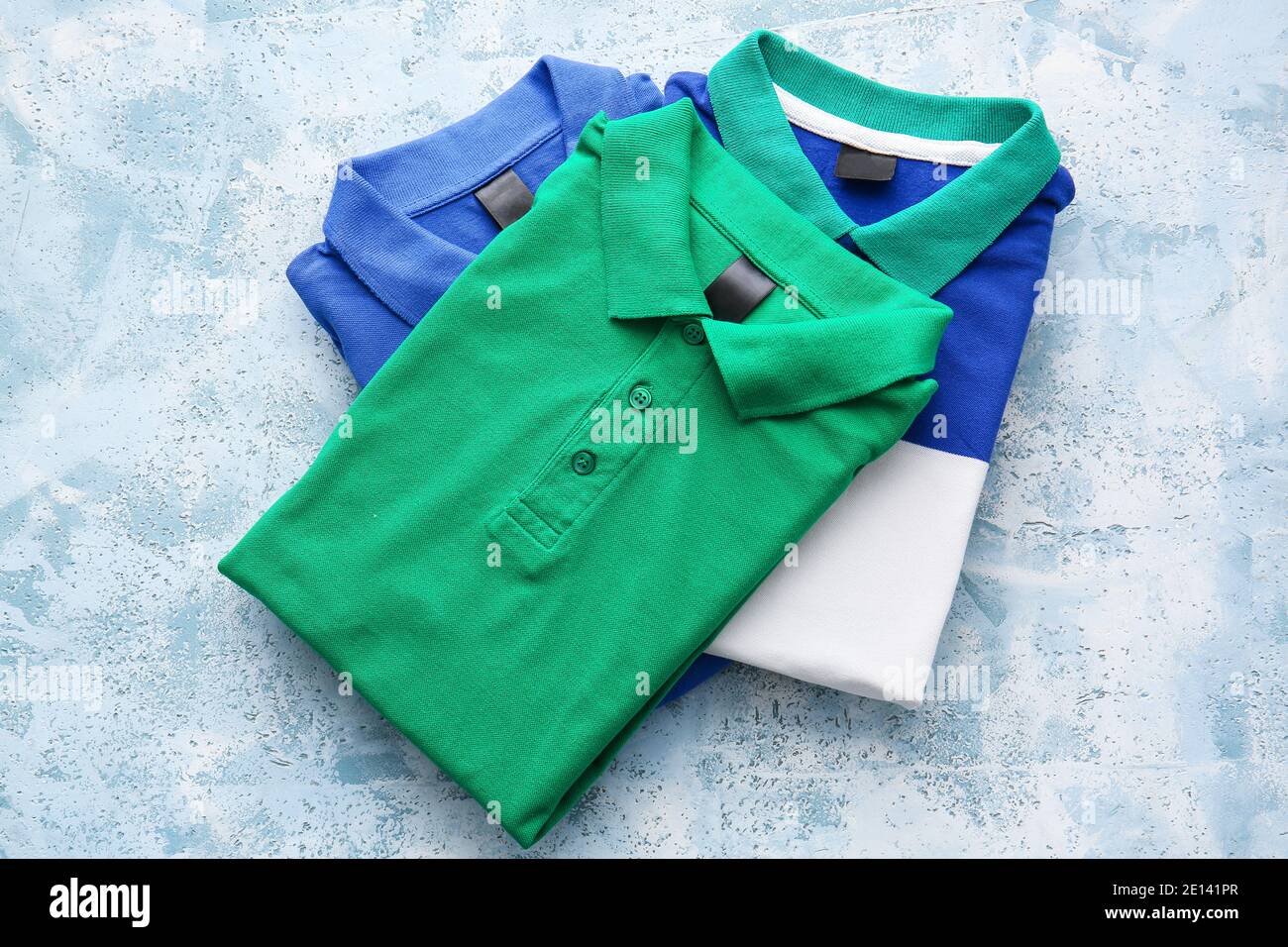 Folded polo shirts on light background Stock Photo - Alamy