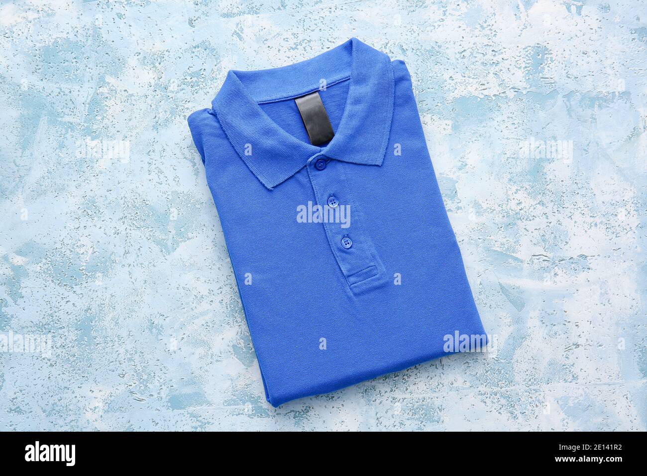 Folded polo shirt on light background Stock Photo - Alamy