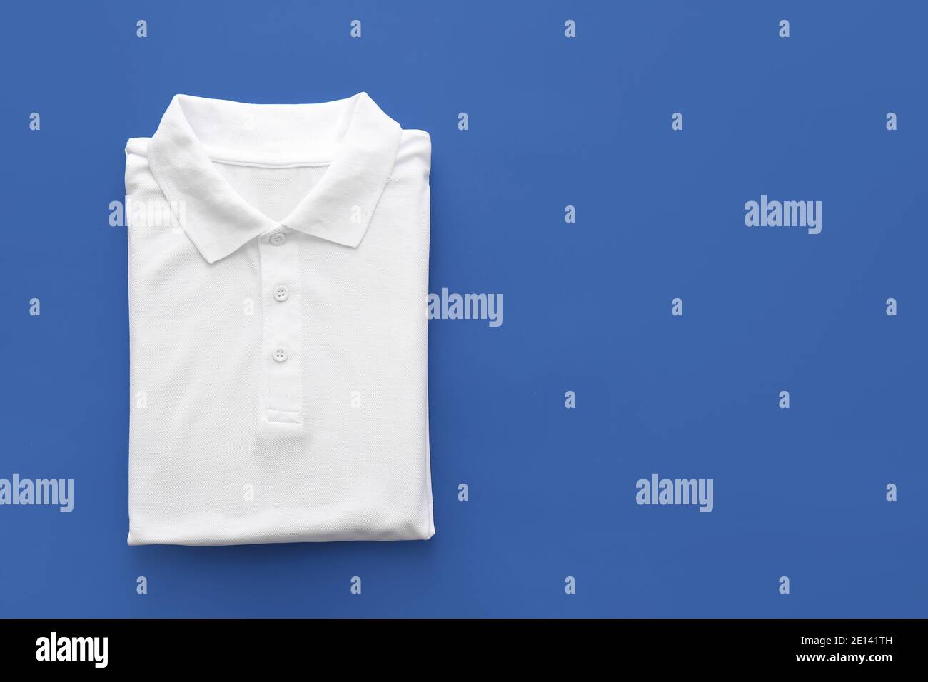 Folded polo shirt on color background Stock Photo - Alamy