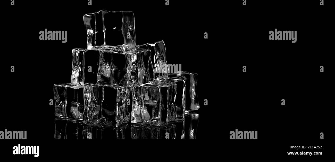 Ice cubes are arranged in a slide, isolated on a black background ...