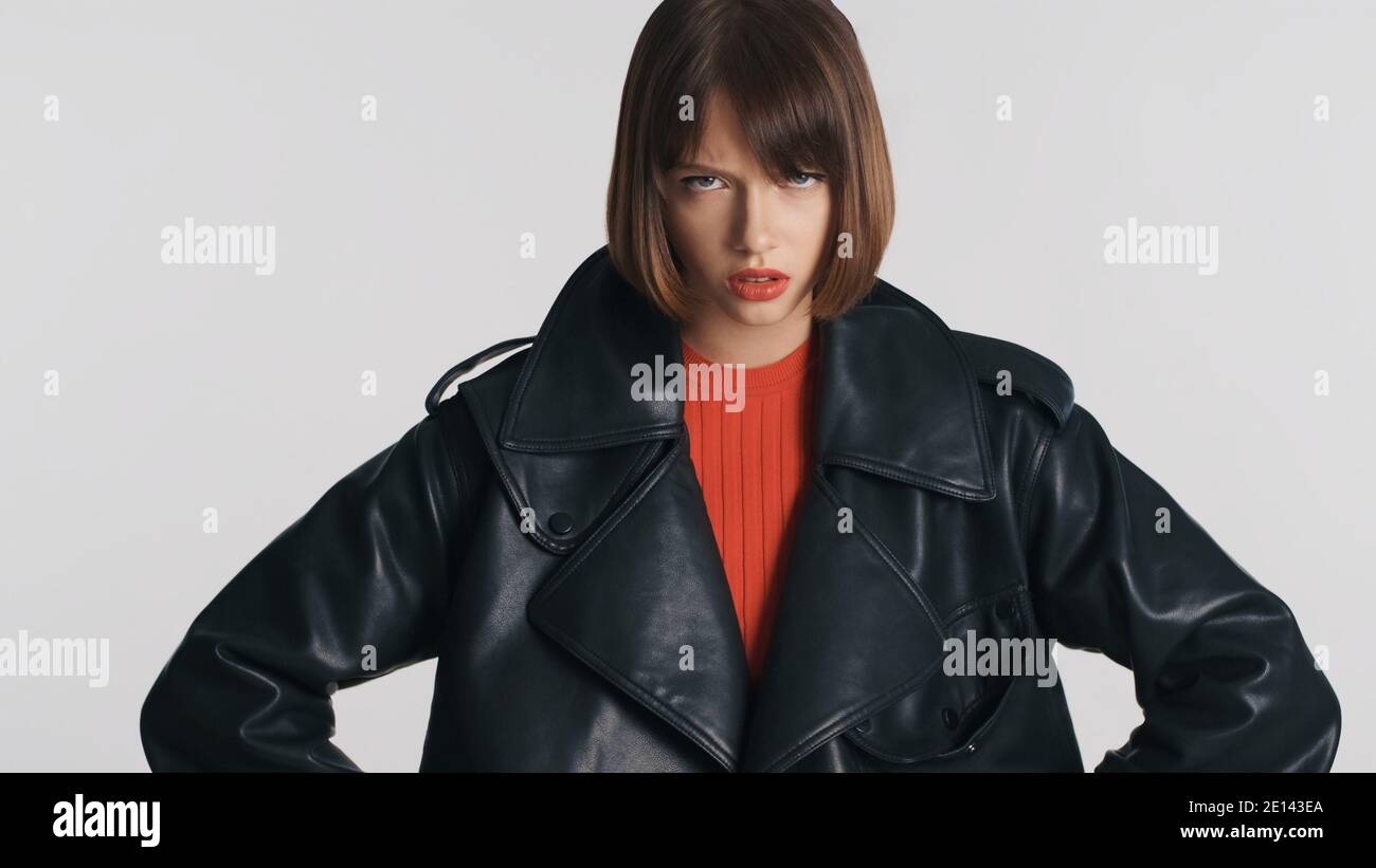 Annoyed aggressive brunette girl with bob hair and red lips looking ...