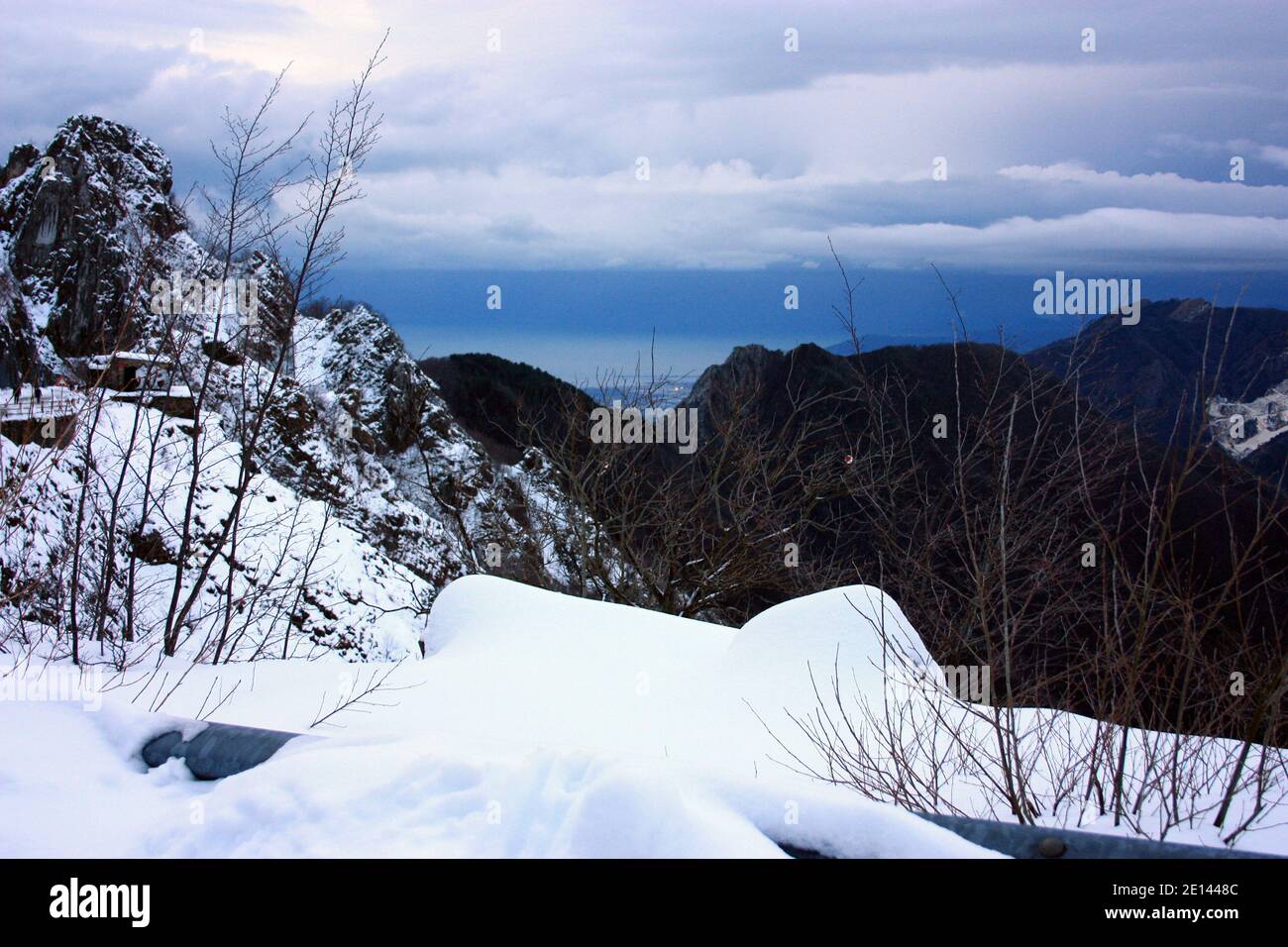 top of the mountains of the Apuan Alps covered with white snow and the ...