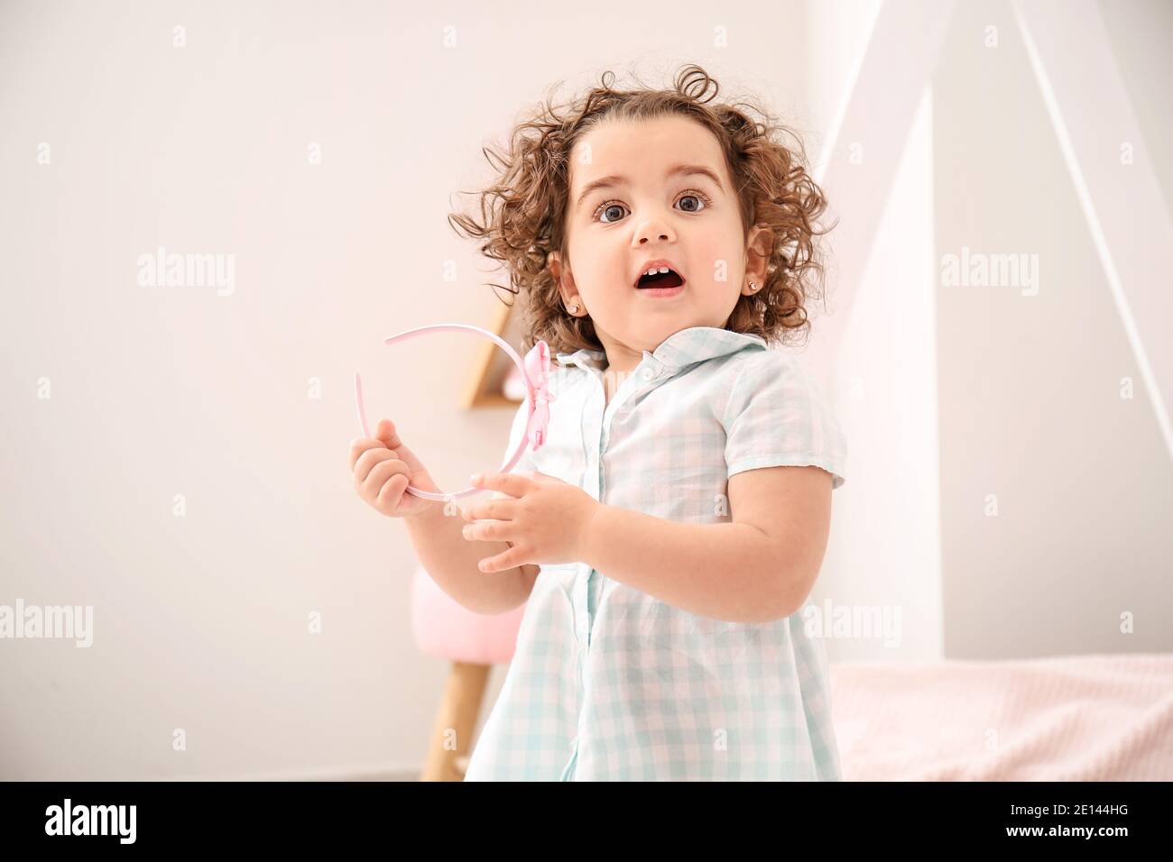 Surprised baby girl at home Stock Photo - Alamy