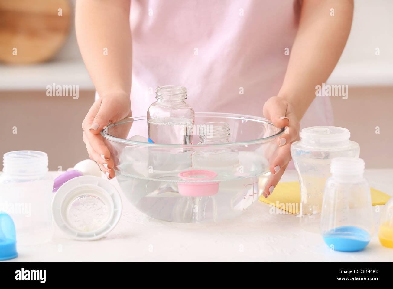 Mother cleaning baby milk bottles hi-res stock photography and images ...