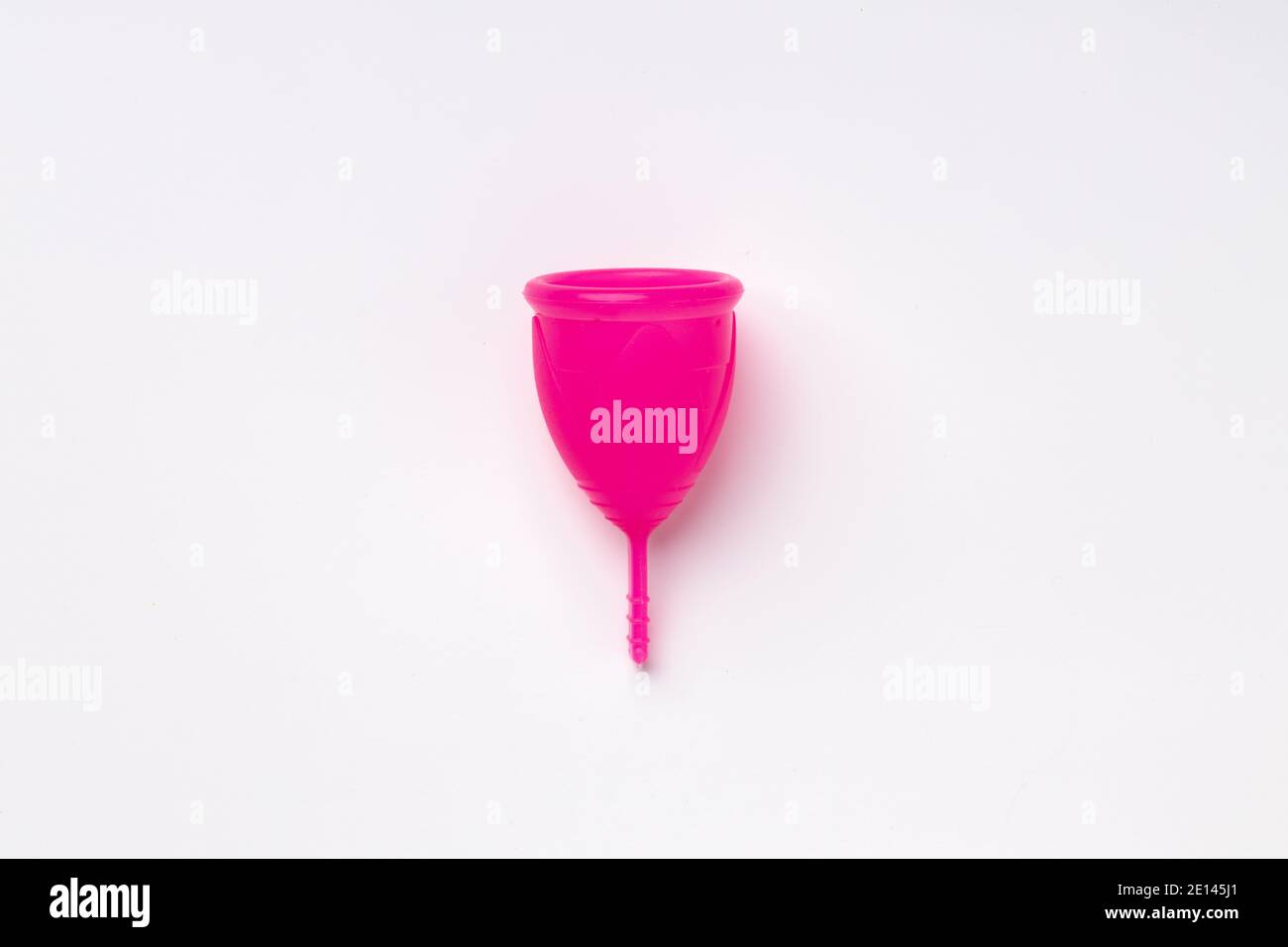 Pink silicone menstrual cup on white background Stock Photo - Alamy