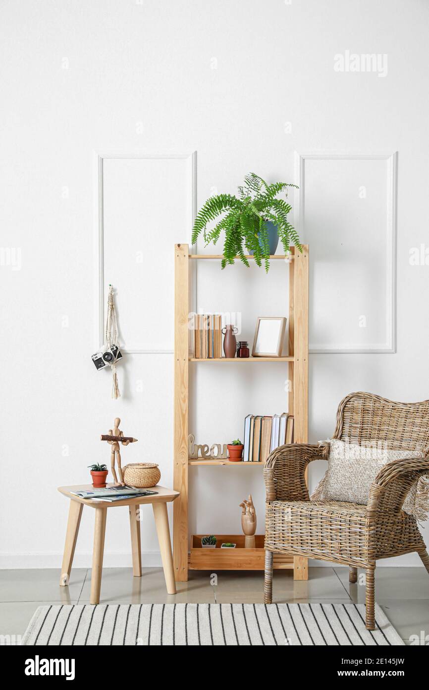 Interior of modern room with shelf unit and armchair Stock Photo - Alamy