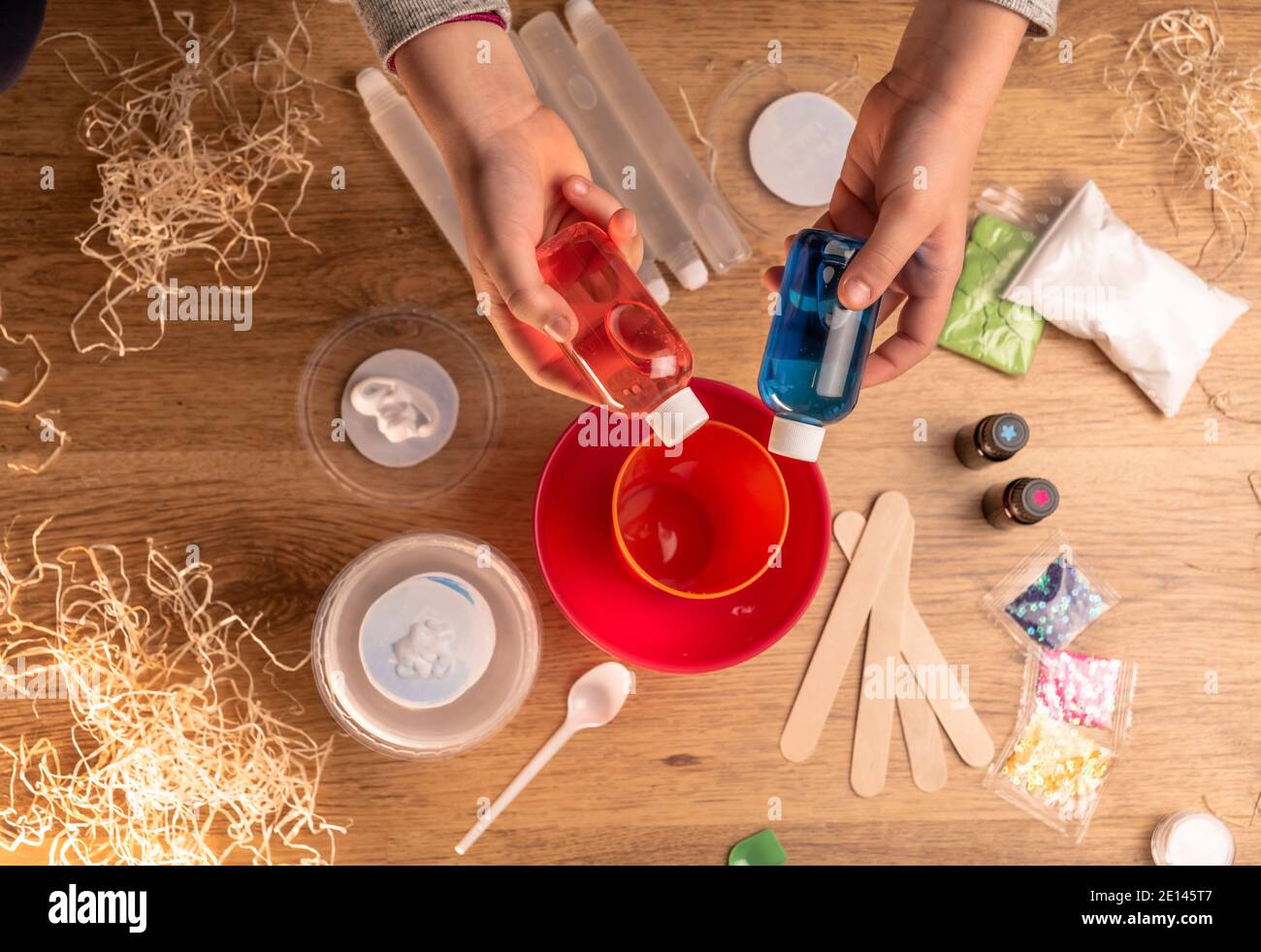 Kids hands making slime toy at home. Making slime. Ingredients and ...