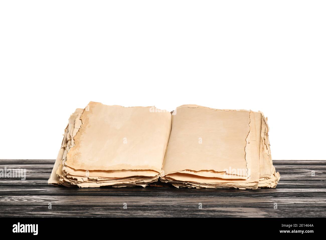 Open old book on table against white background Stock Photo - Alamy