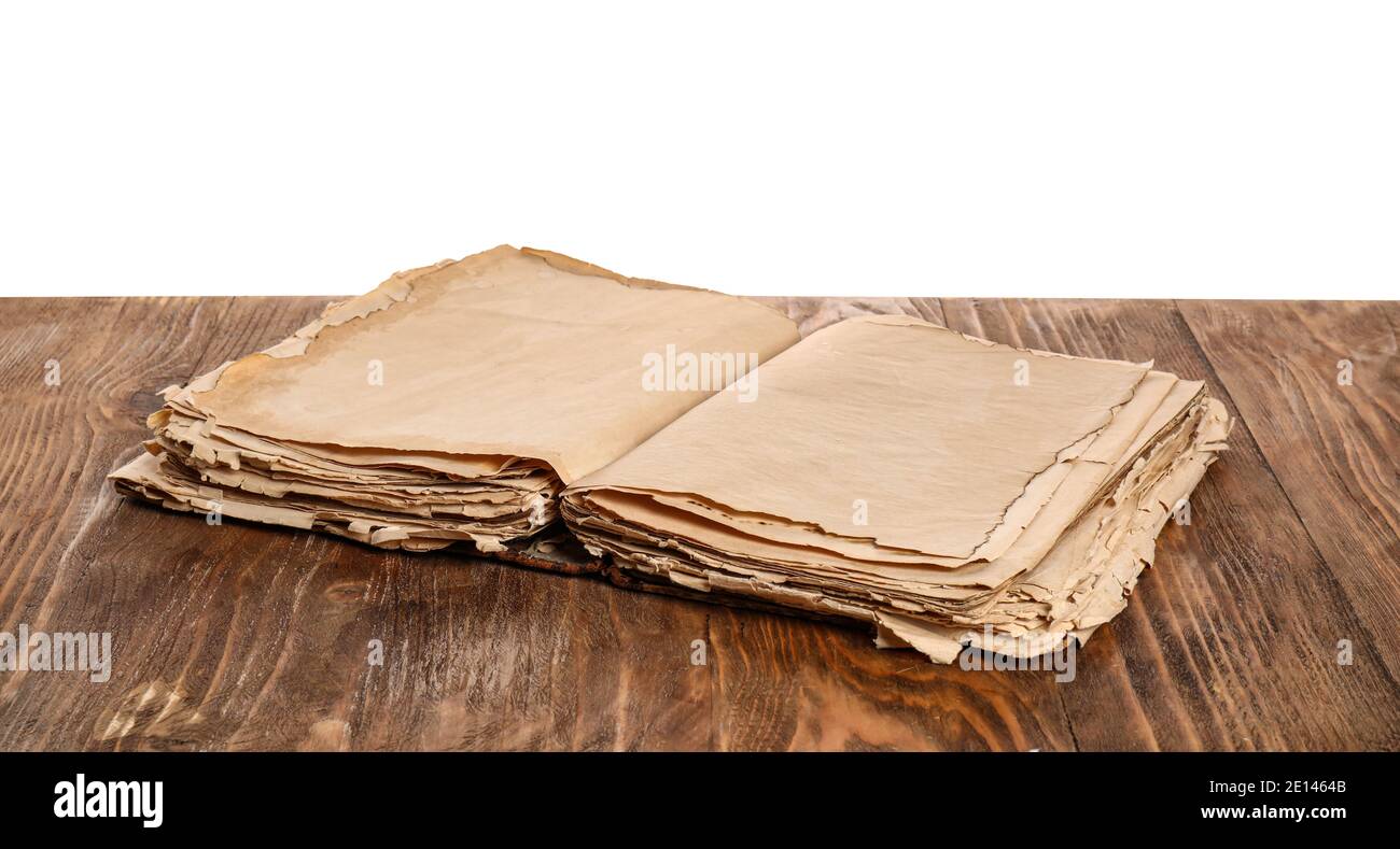 Open old book on table against white background Stock Photo - Alamy