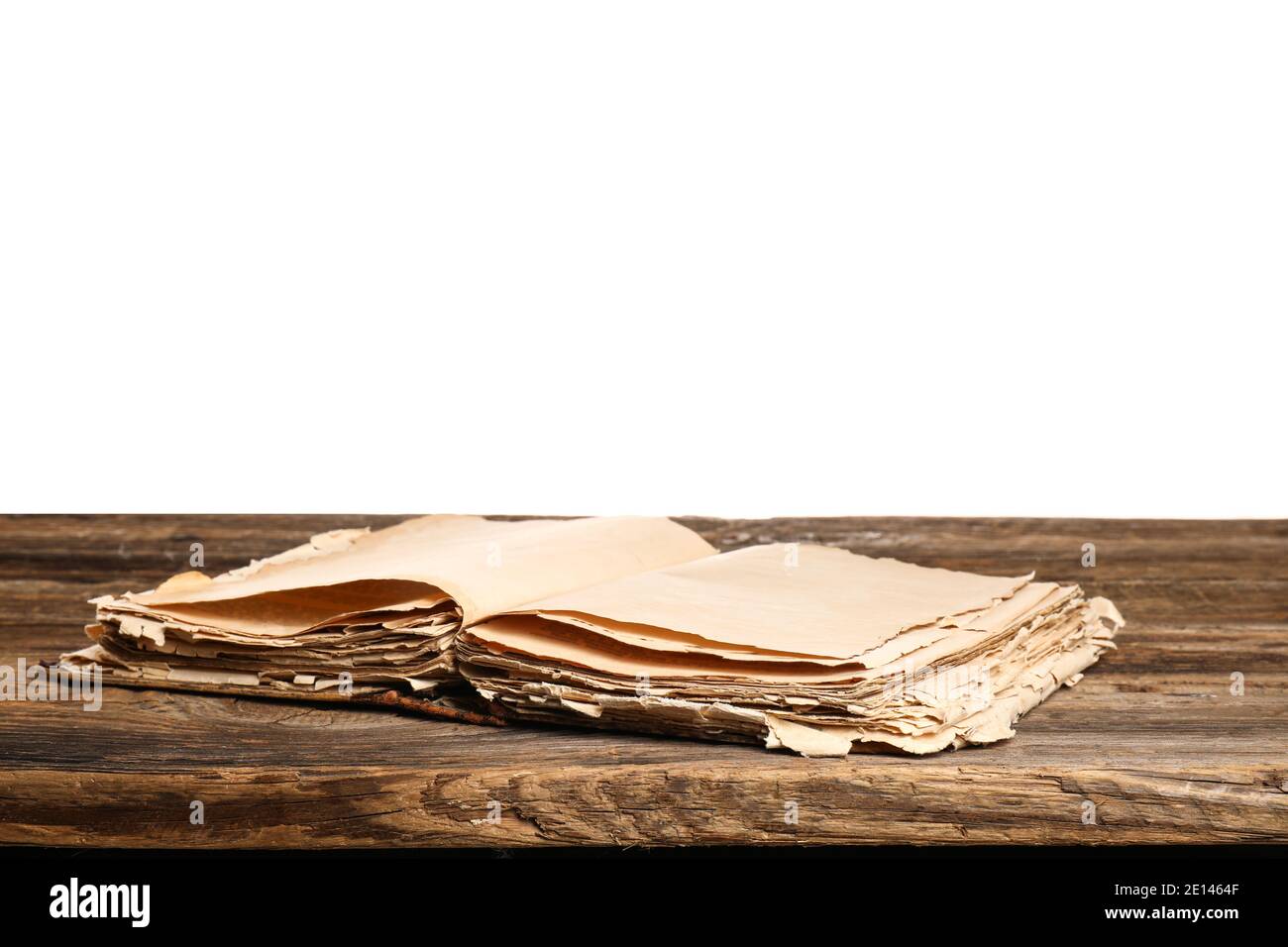 Open old book on table against white background Stock Photo - Alamy