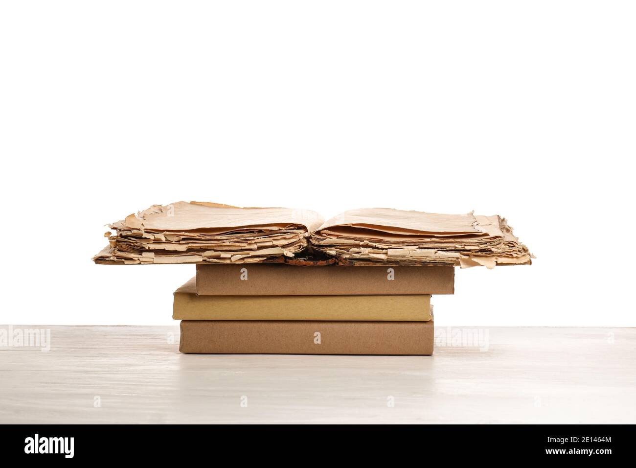 Old books on table against white background Stock Photo - Alamy
