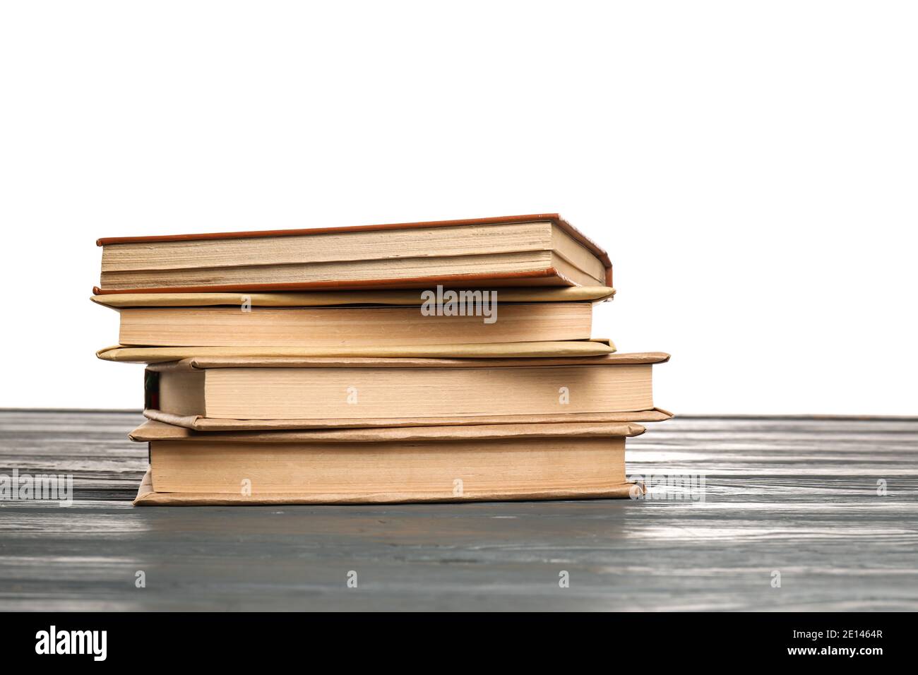 Old books on table against white background Stock Photo - Alamy