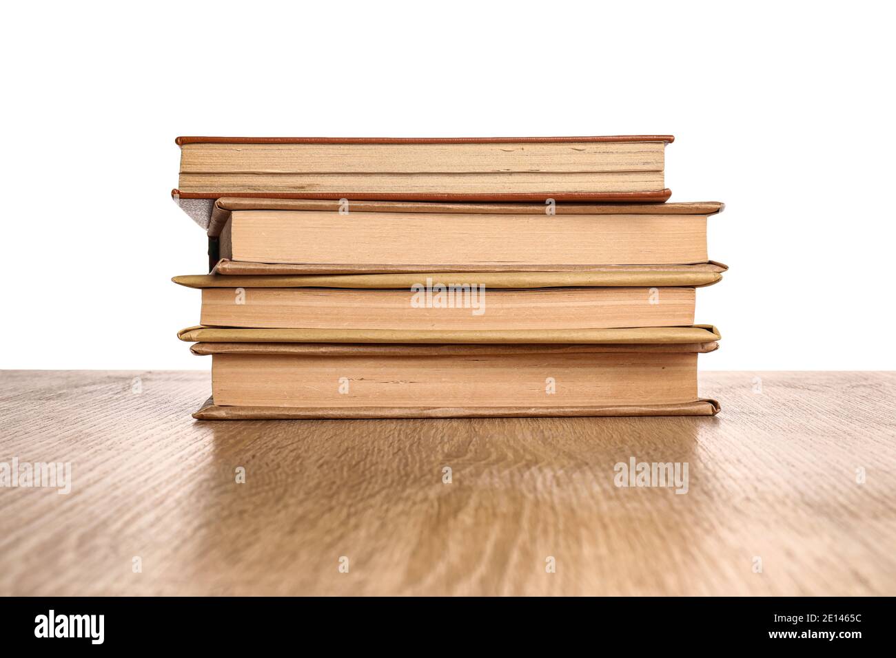 Old books on table against white background Stock Photo - Alamy