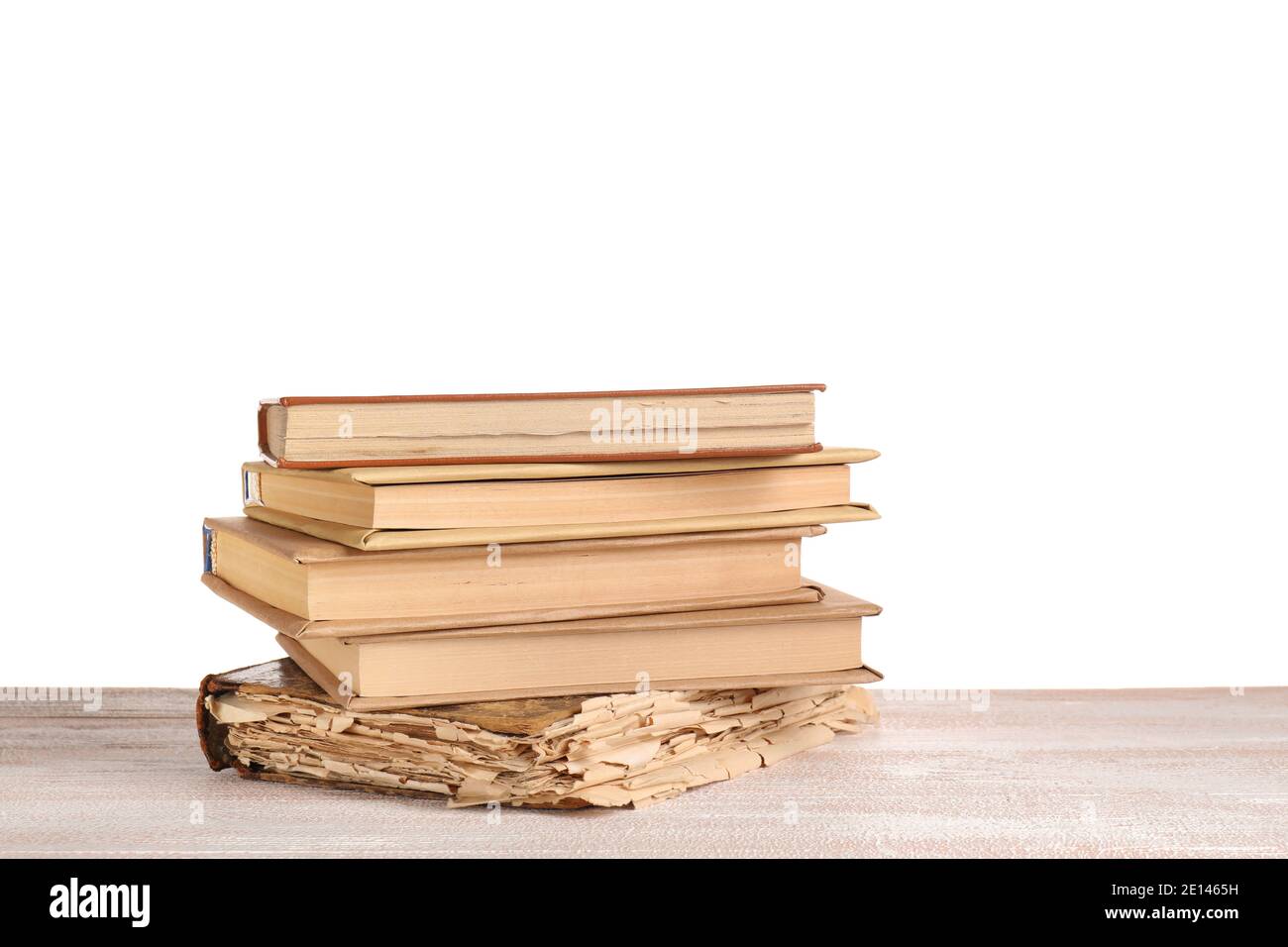 Old books on table against white background Stock Photo - Alamy