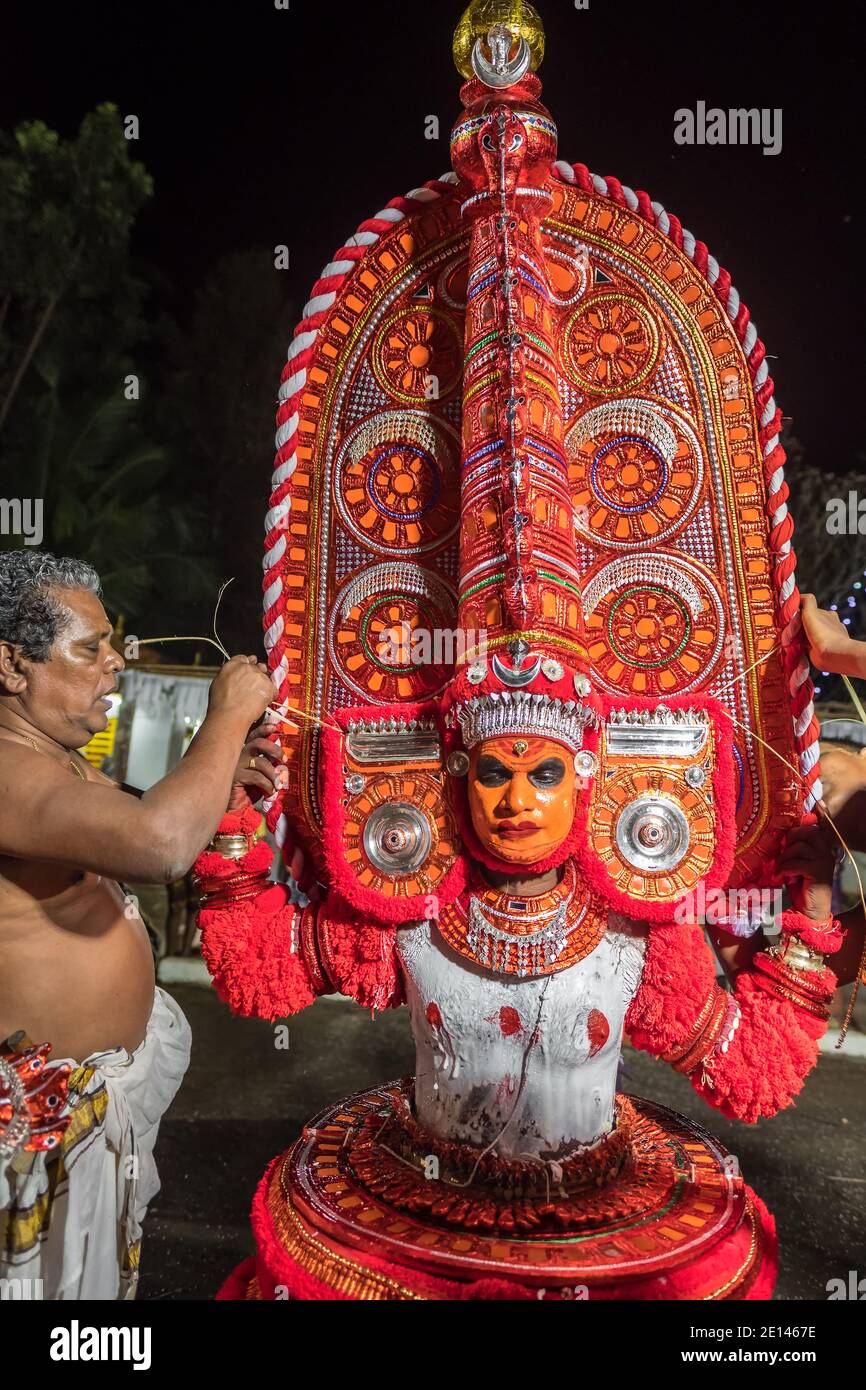 Theyyam artist preparing to perform during temple festival in Payyanur ...