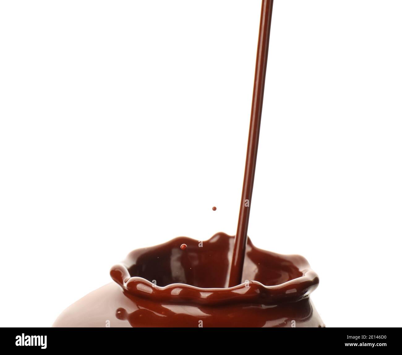 Pouring of hot chocolate in cup on white background Stock Photo - Alamy