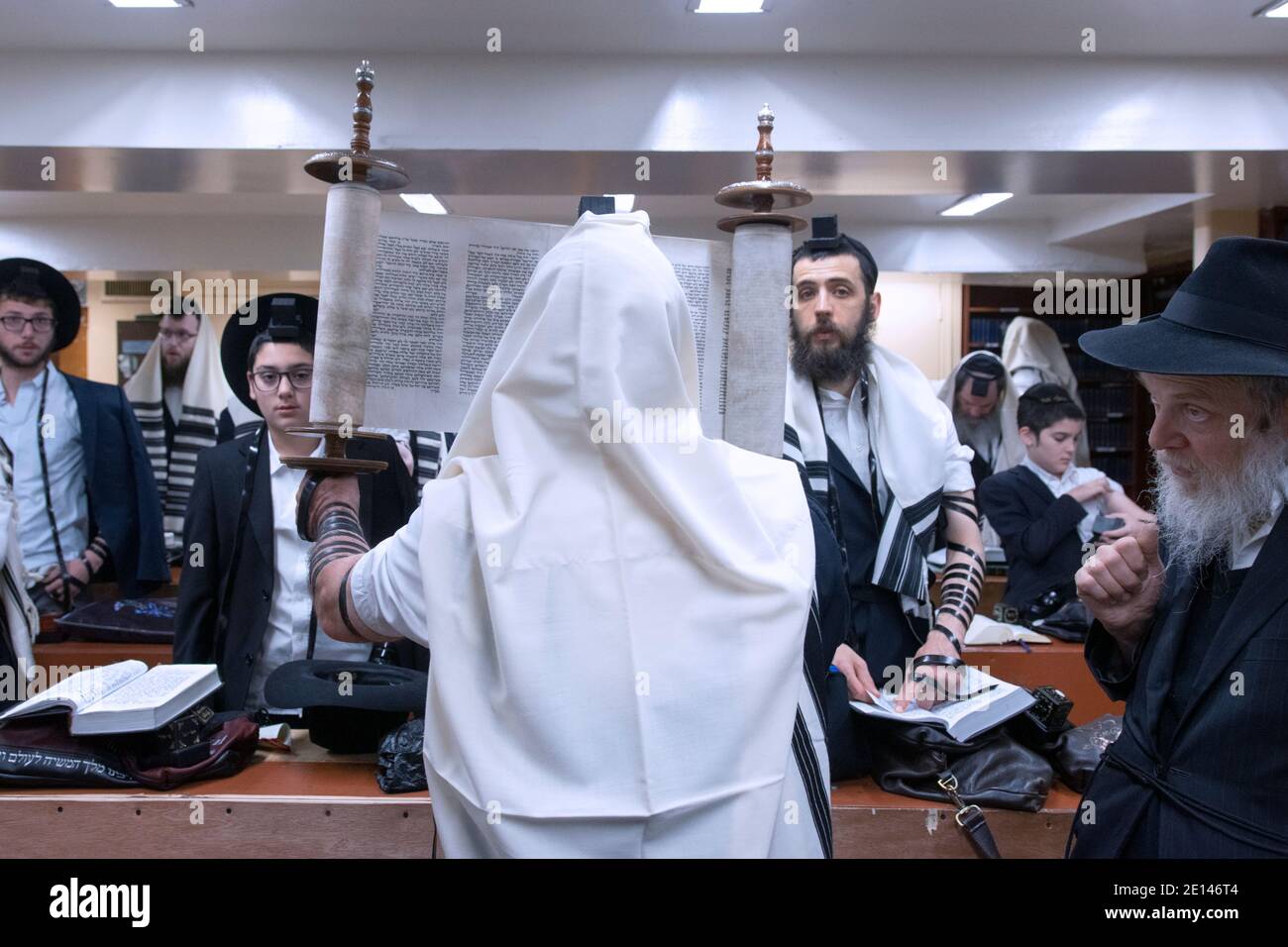 After a Torah reading at a synagogue, a man shows the letters of the ...