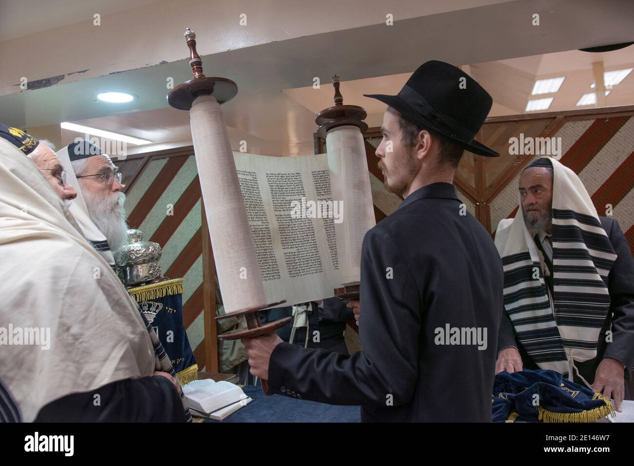 After a Torah reading at a synagogue, a man shows the letters of the ...
