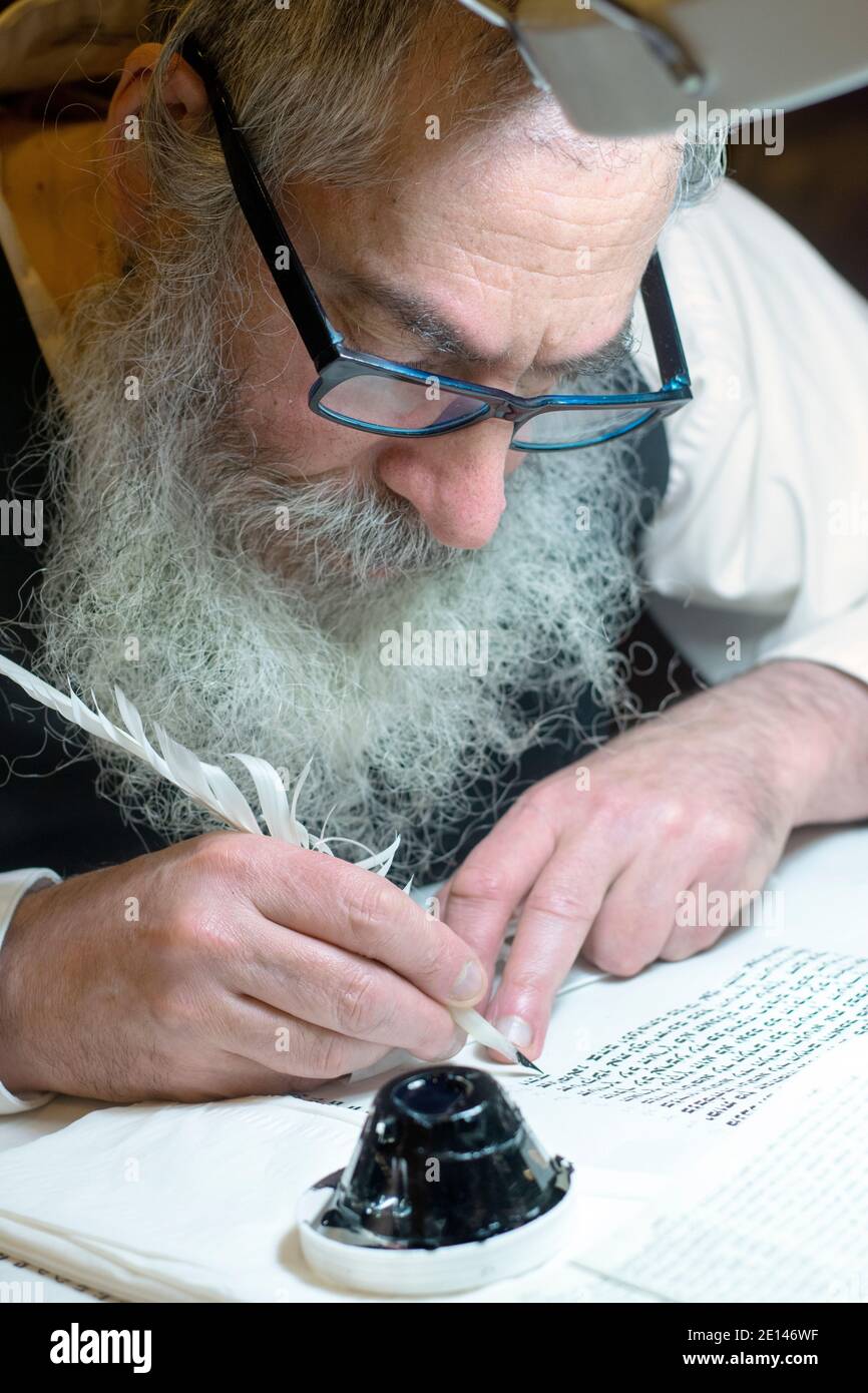 Close up photo of a rabbi scribe writing a Torah scroll. In Brooklyn ...