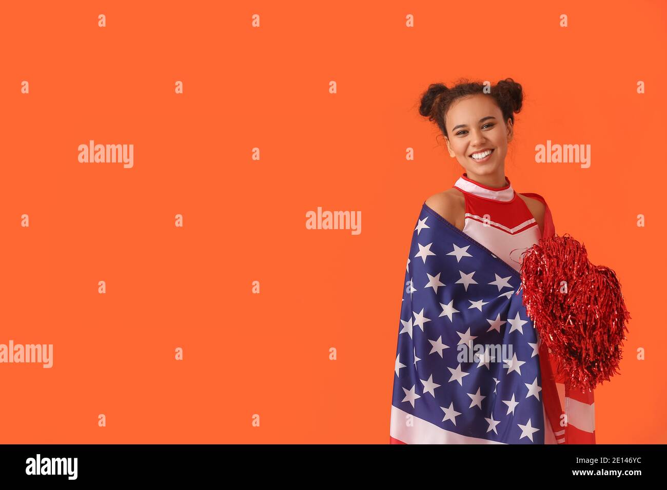 Beautiful young cheerleader with USA flag on color background Stock ...