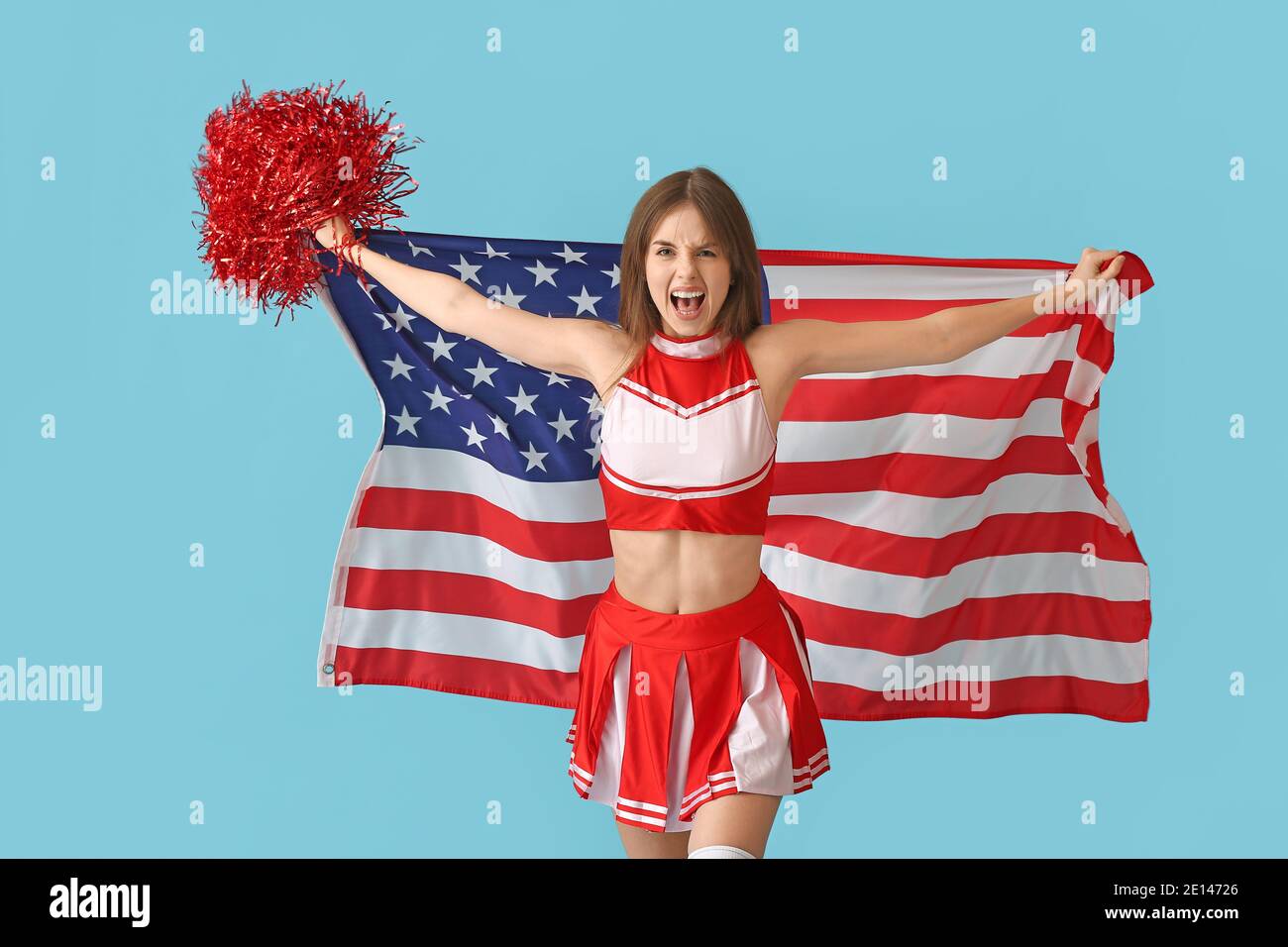 Emotional cheerleader with USA flag on color background Stock Photo - Alamy