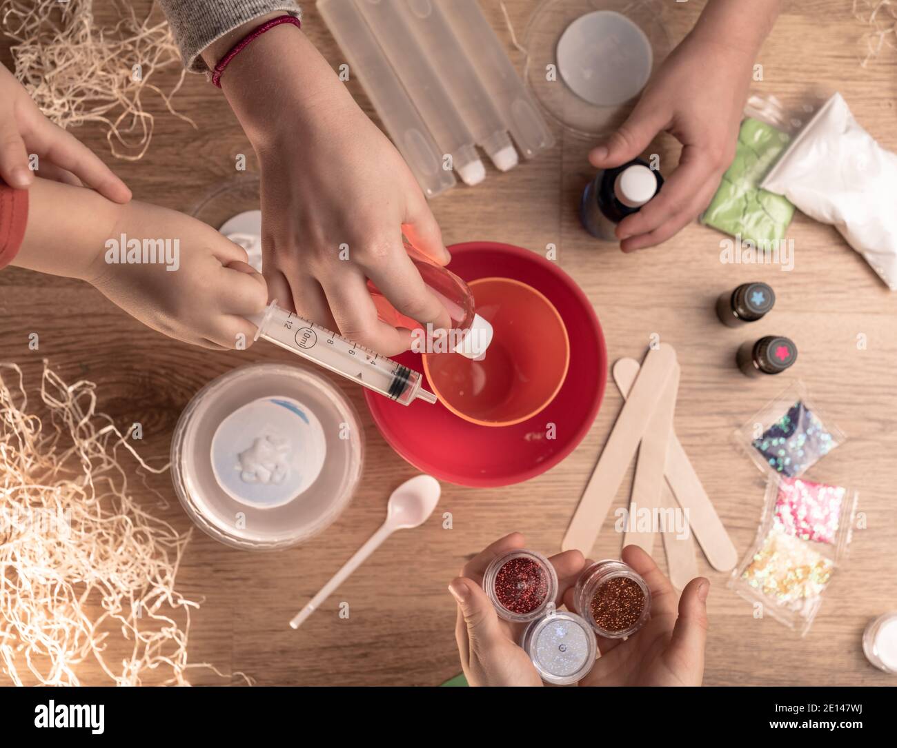 Kids hands making slime toy at home. Making slime. Ingredients and ...