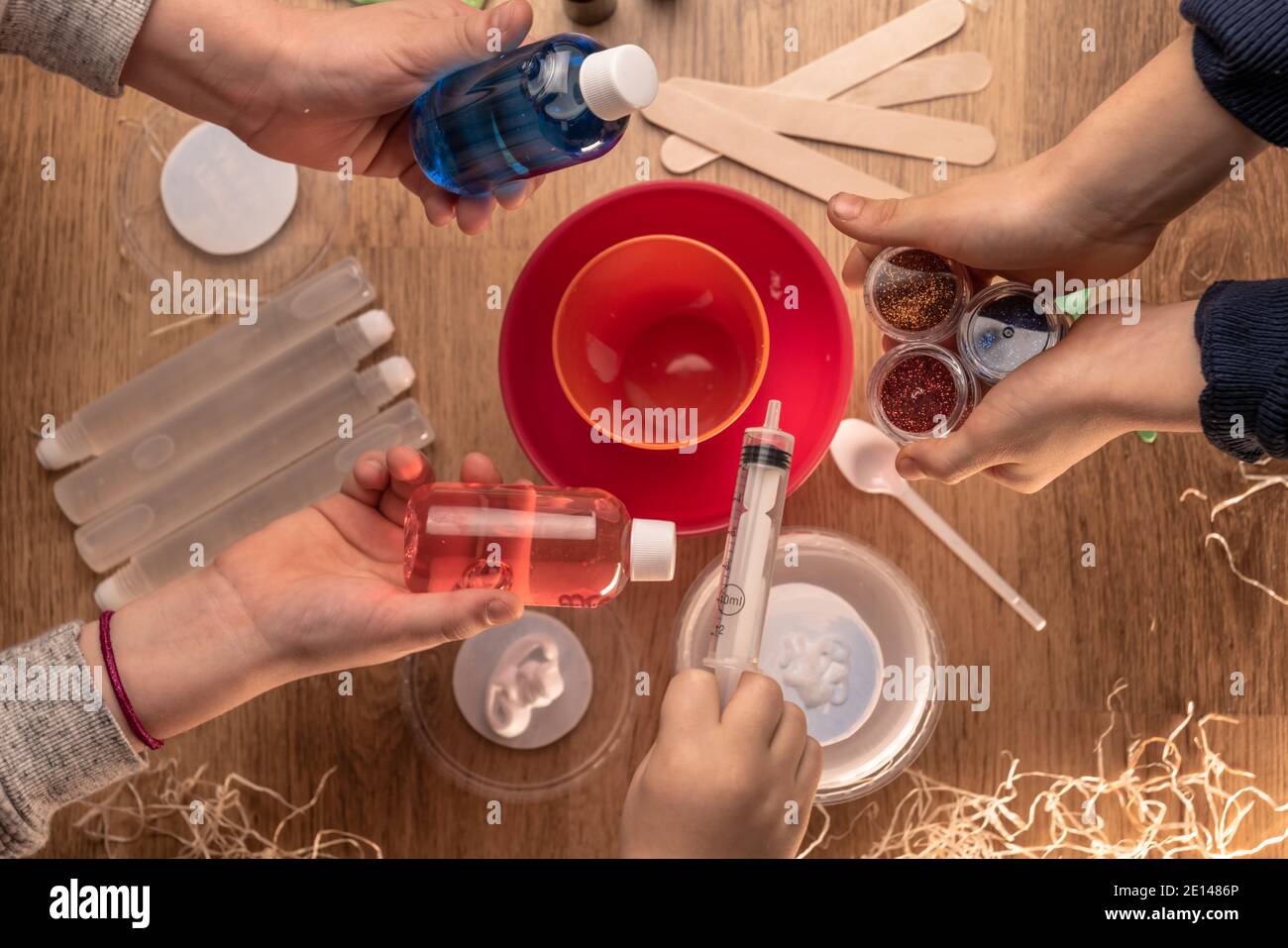 Kids hands making slime toy at home. Making slime. Ingredients and ...