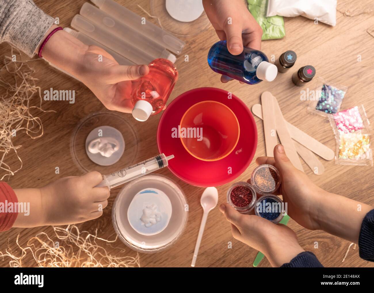 Kids hands making slime toy at home. Making slime. Ingredients and ...