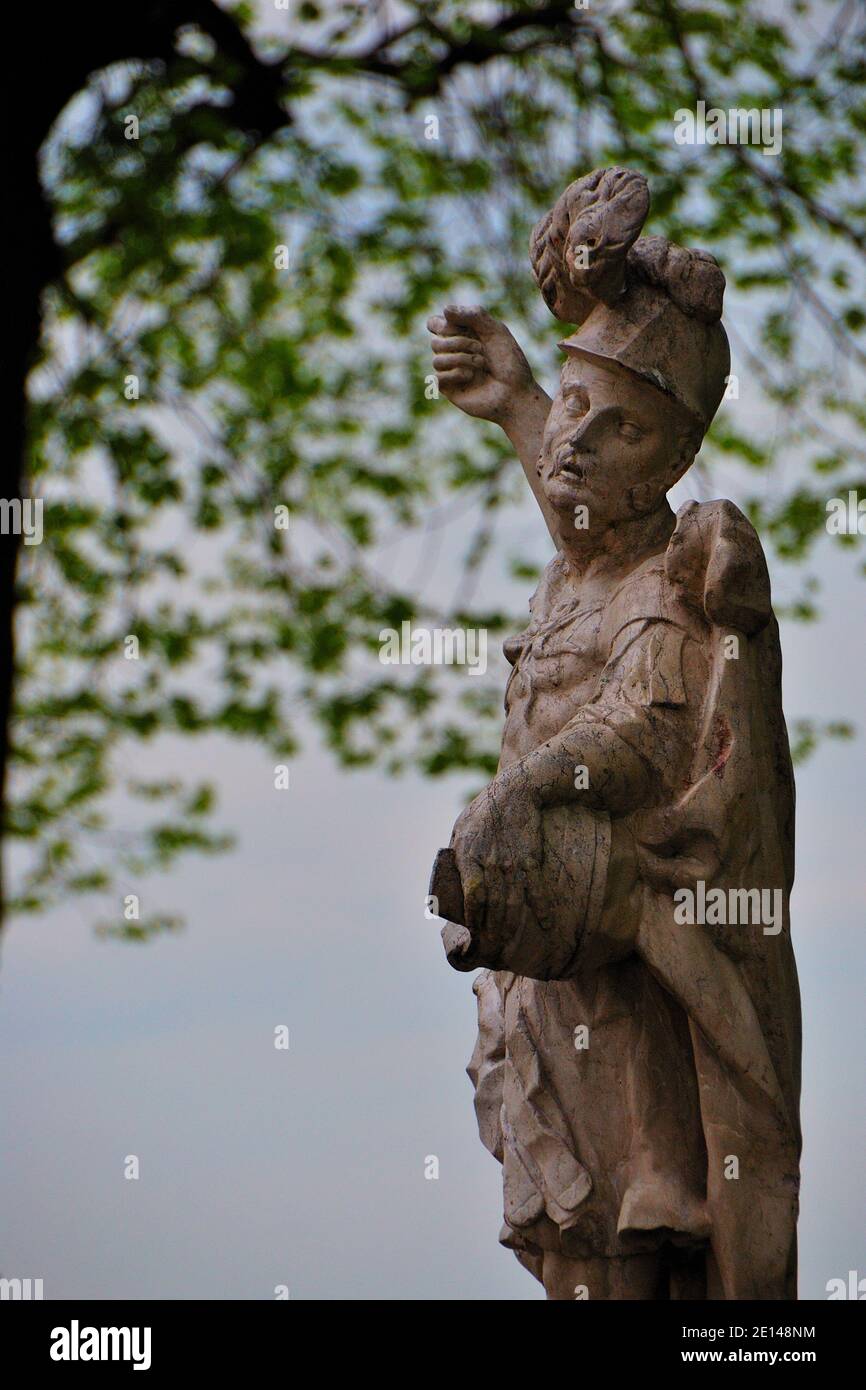 statue made ??of stone with a tree Stock Photo - Alamy