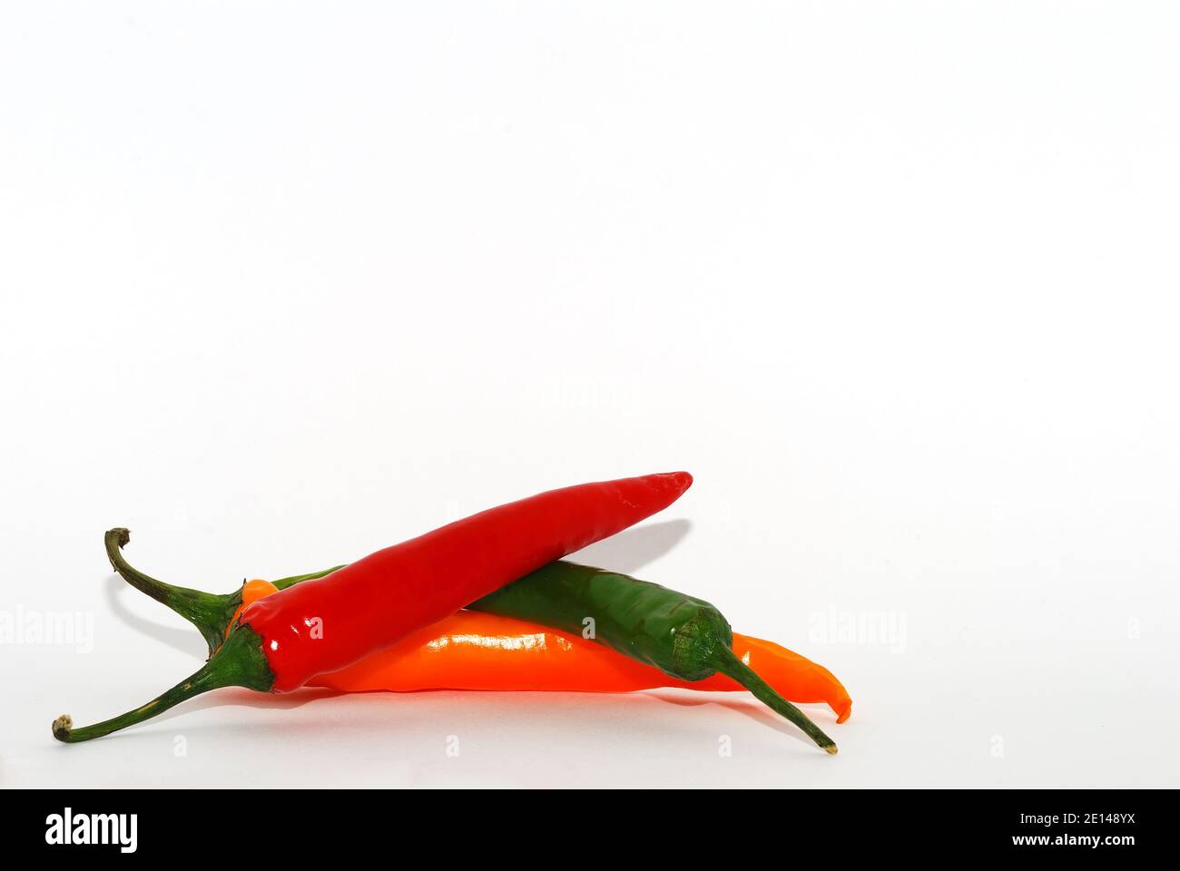 colorful chilli pepper on white background Stock Photo - Alamy