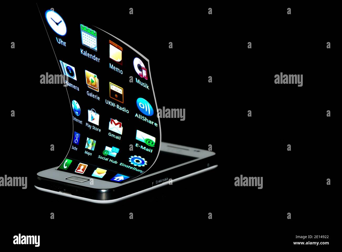 mobile phone with curved edges and flipped desktop on black background ...