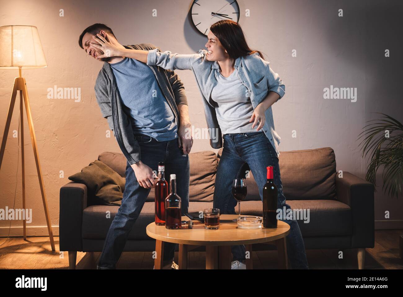 drunk woman fighting with husband near table with alcohol drinks at ...