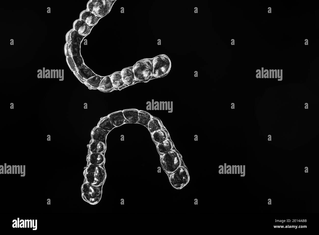 Invisible dental teeth brackets tooth aligners on black background ...