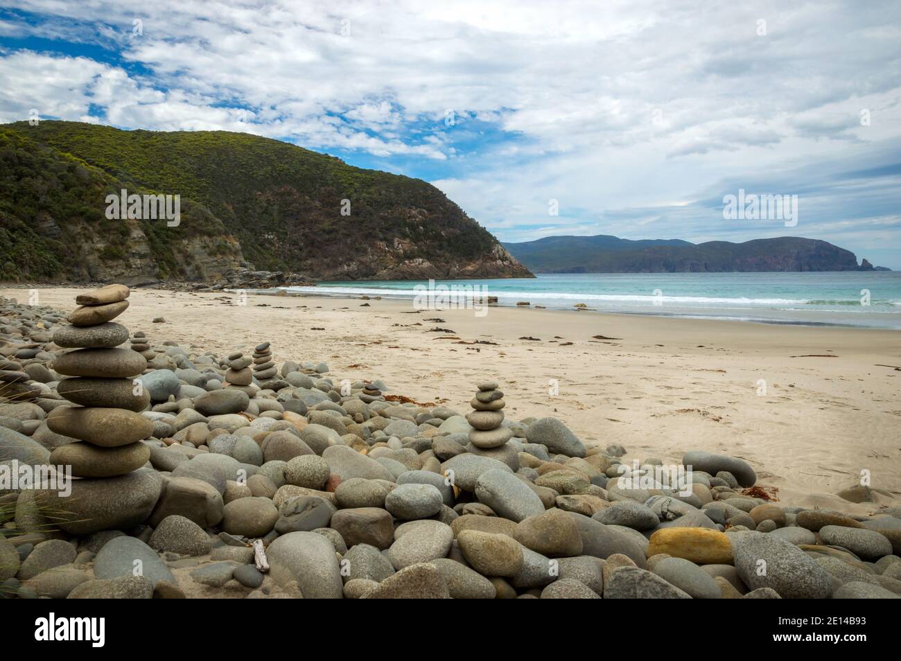 Paradise beach building pebbles piles Stock Photo - Alamy