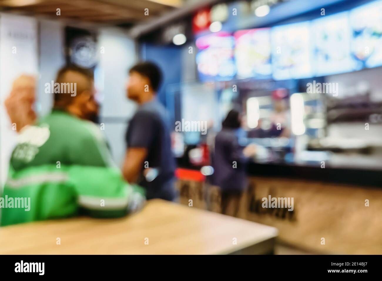 Lens Blurred image of people queueing to see and ordering food items in ...
