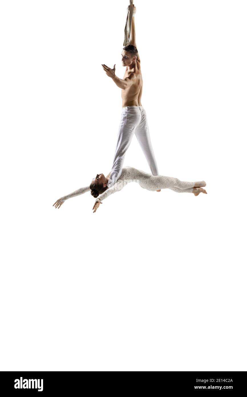 Lovely. Couple of acrobats, circus athletes isolated on white studio ...
