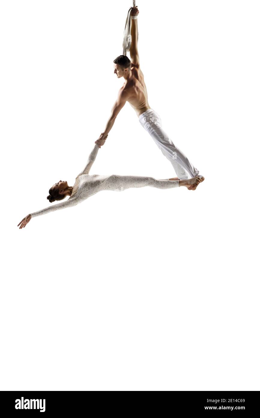 Touch. Couple of acrobats, circus athletes isolated on white studio ...