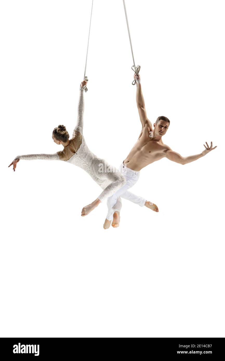 Fighting. Couple of acrobats, circus athletes isolated on white studio ...