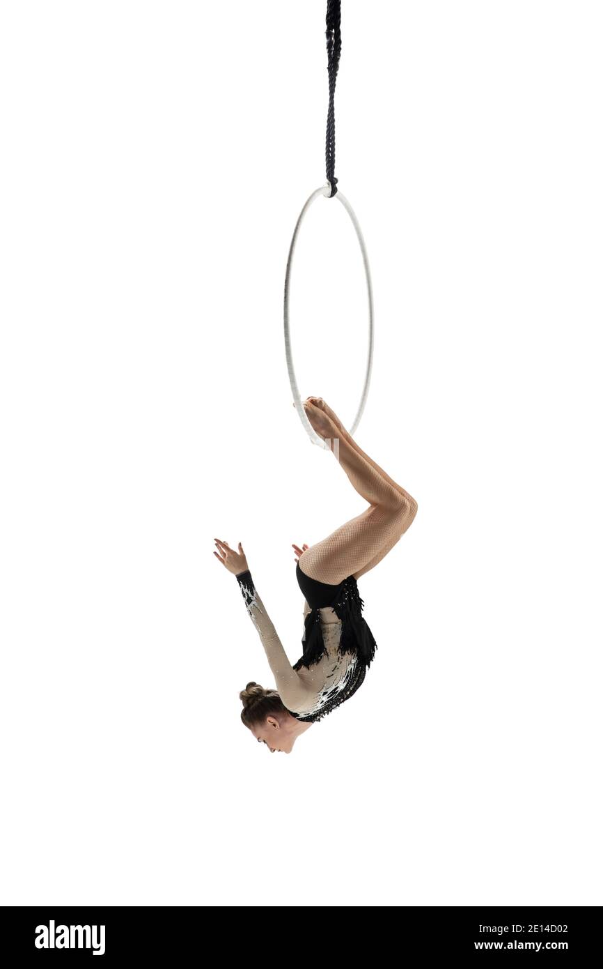 Holding. Young female acrobat, circus athlete isolated on white studio ...