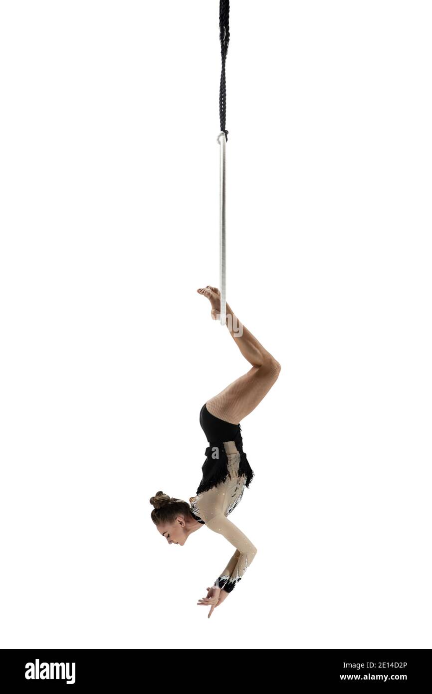Balancing. Young female acrobat, circus athlete isolated on white ...