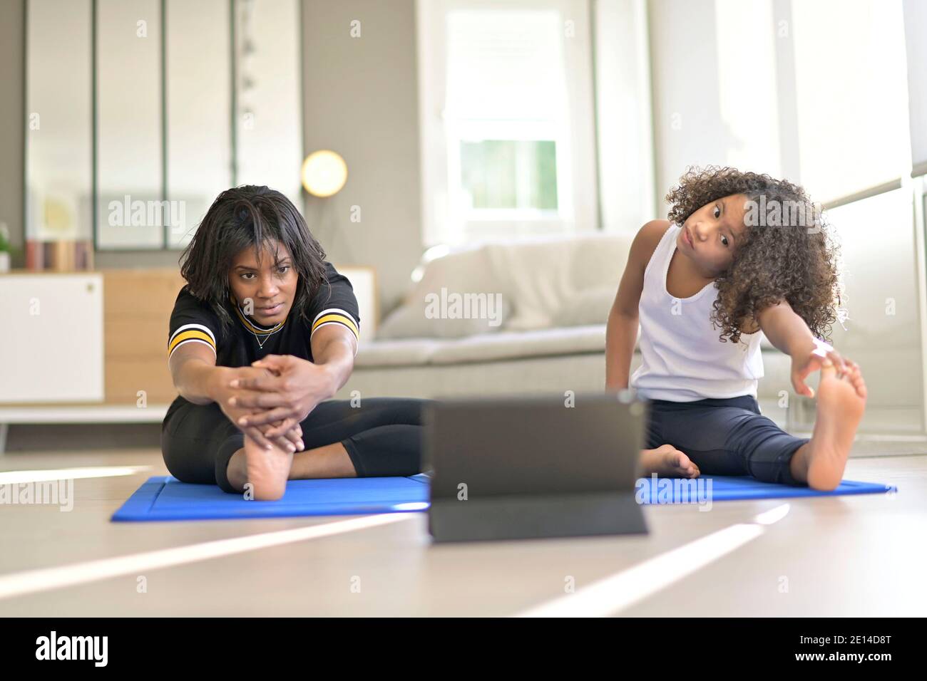 Mother and daughter doing fitness exercices at home Stock Photo - Alamy