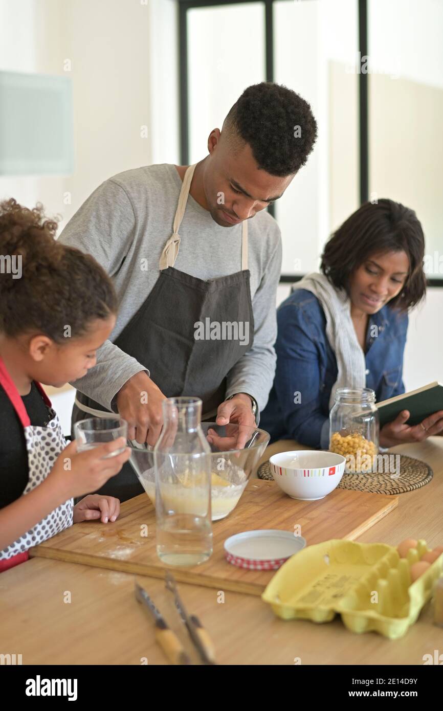 Happy family in home kitchen making homestyle american cookies Stock ...
