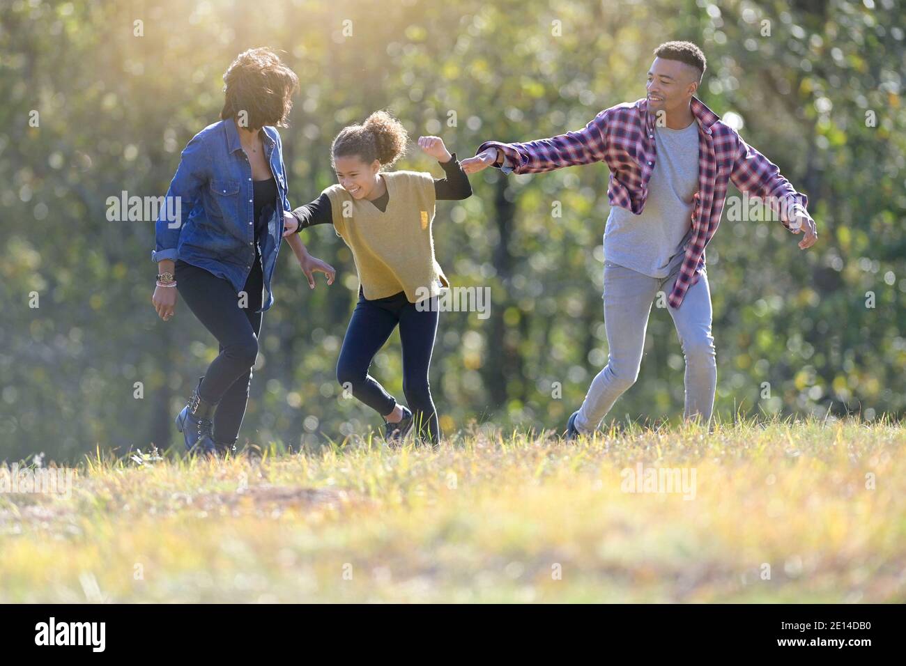 African-american family having fun going for a walk outside in ...