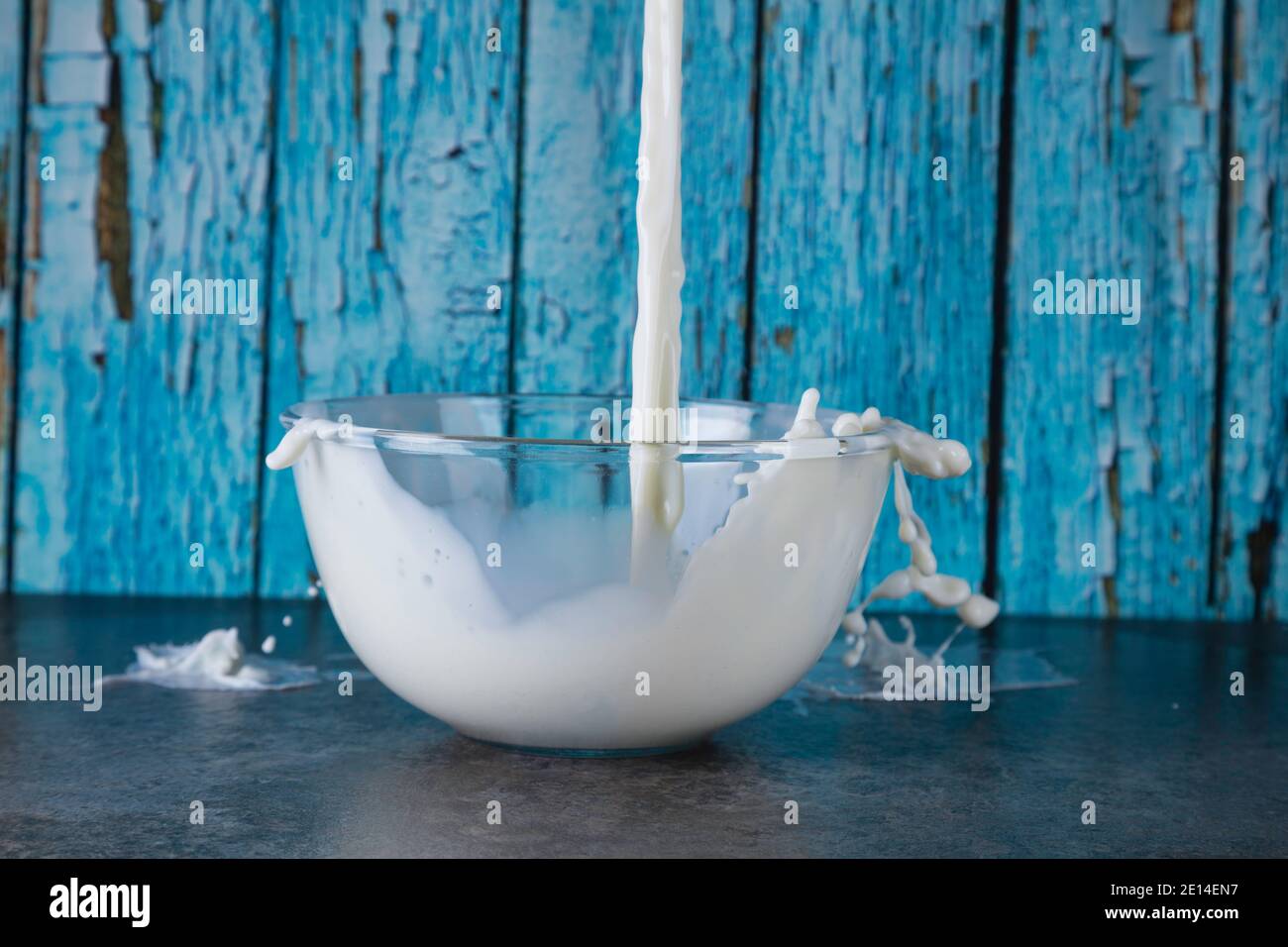 Pouring milk into a bowl in the kitchen Stock Photo - Alamy