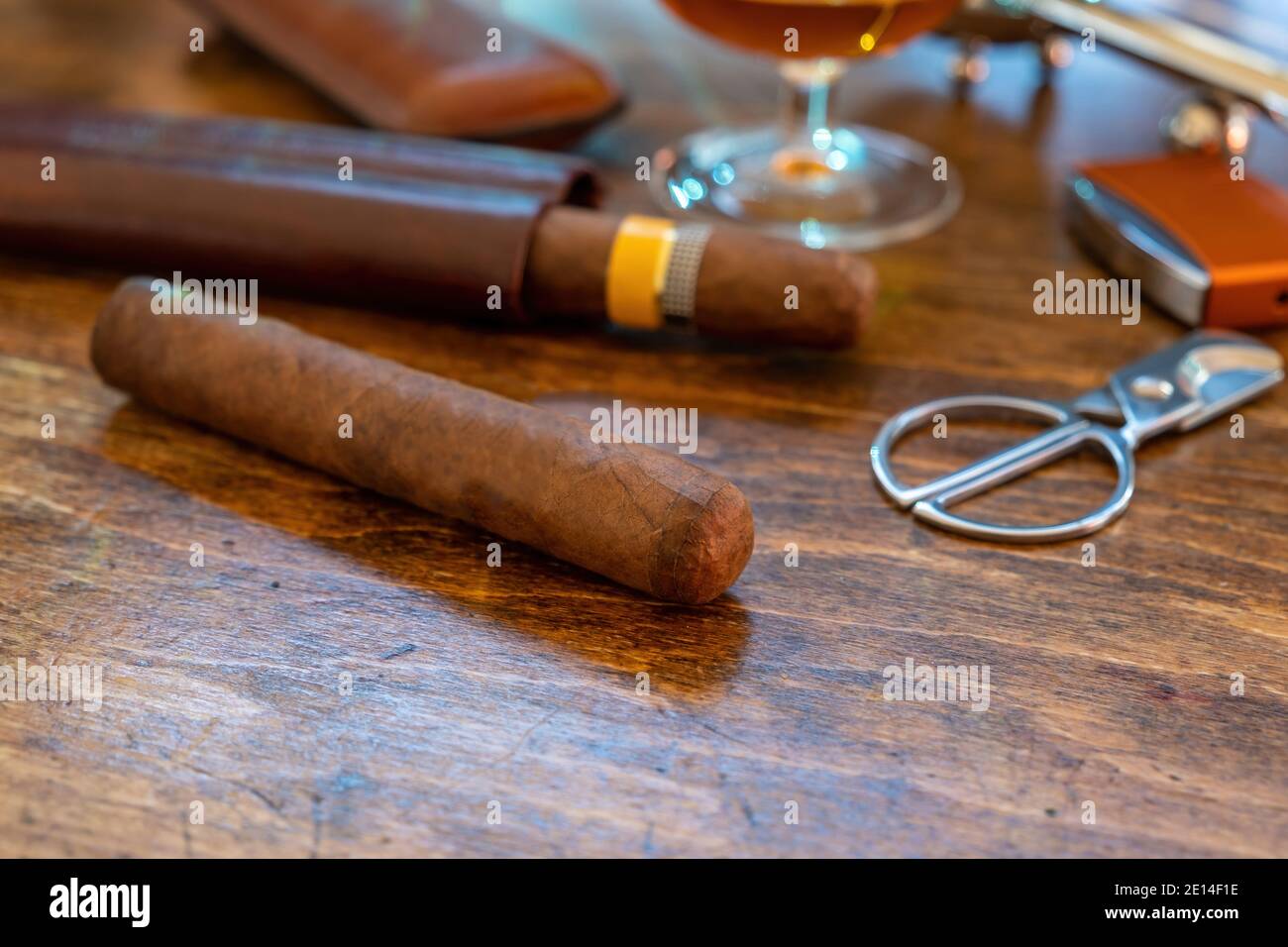 Cigars and accessories on a wooden office desk, closeup view. Cuban ...